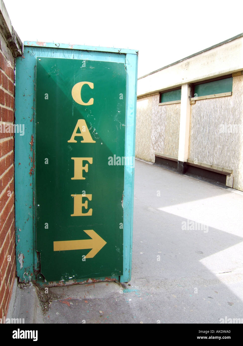 cafe sign with boarded up building Stock Photo - Alamy
