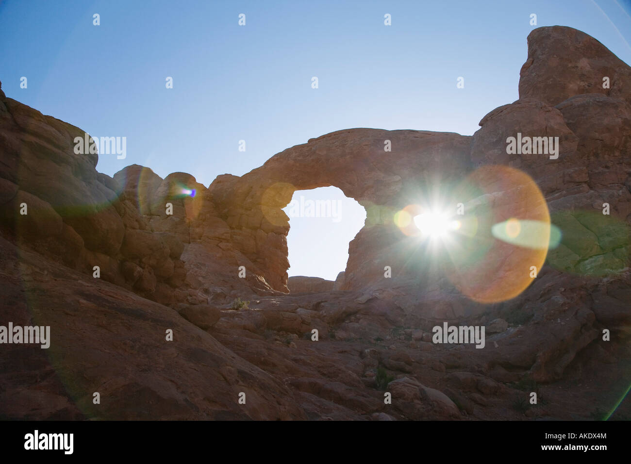 USA, sun shining through rock formation in desert Stock Photo - Alamy