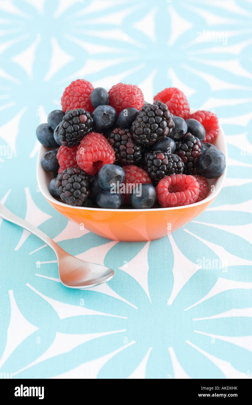 Spoon and bowl of forest fruits Stock Photo - Alamy