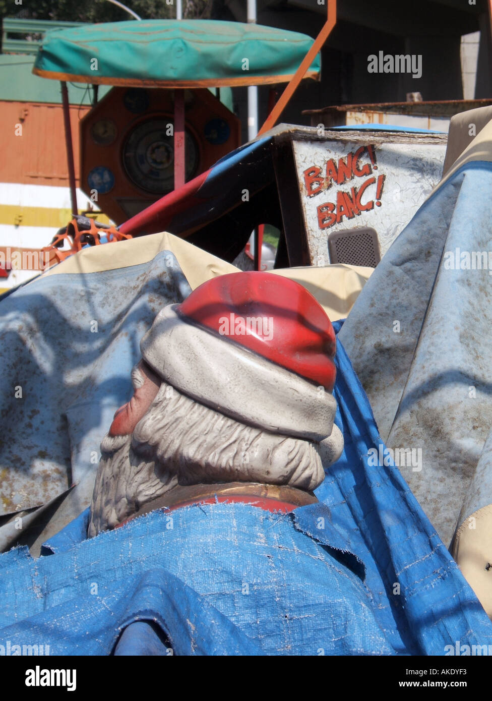 rear view of father christmas model covered with blue tarpaulin in run ...