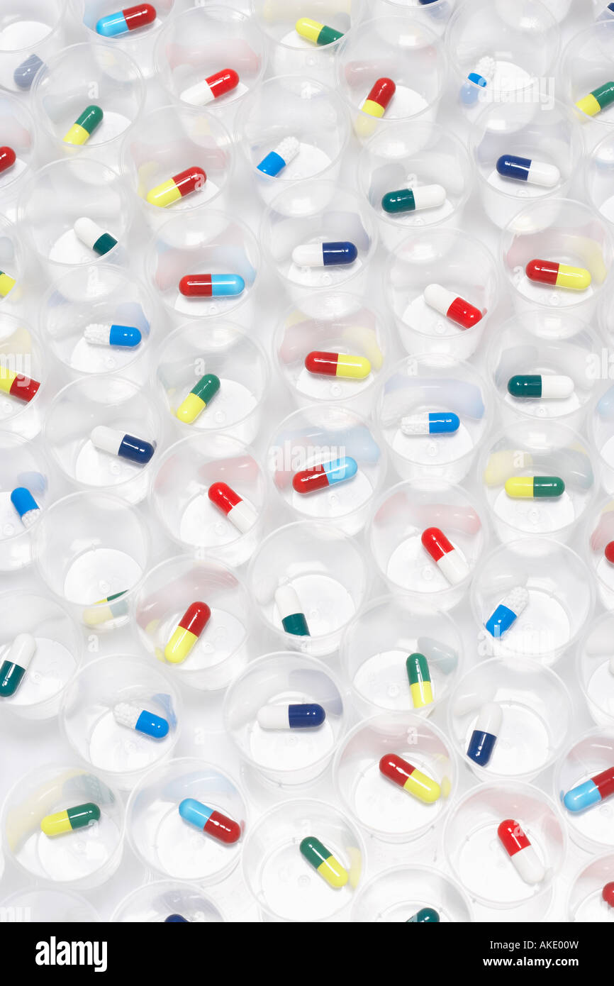 Capsule pills in plastic cups Stock Photo - Alamy