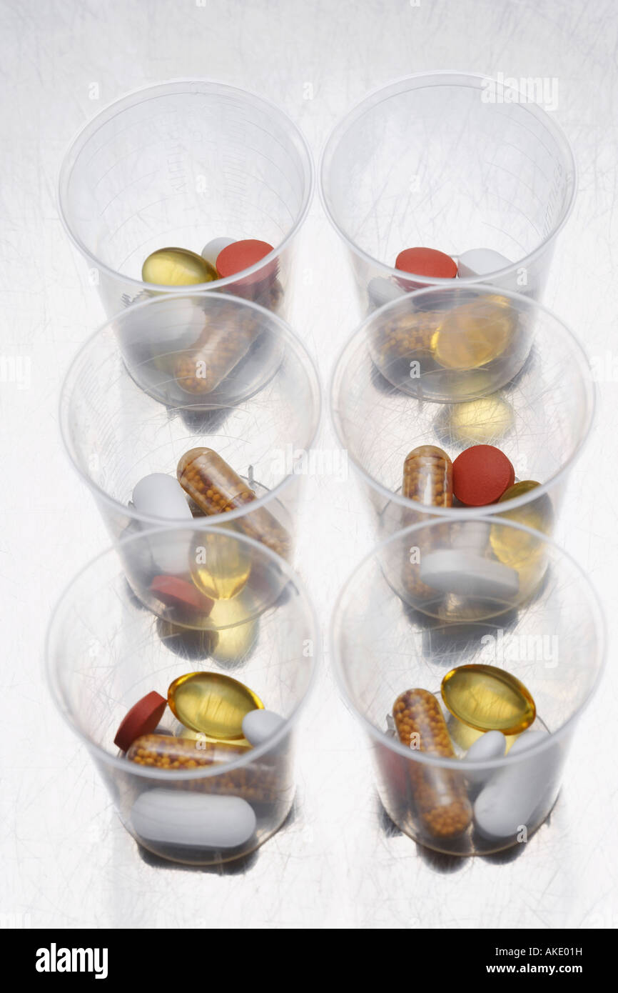 Pills in a plastic cup hi-res stock photography and images - Alamy