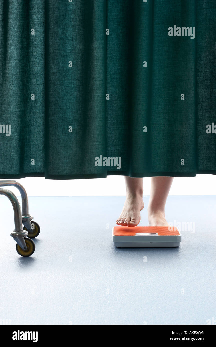 Stepping onto weighing scales hi-res stock photography and images - Alamy