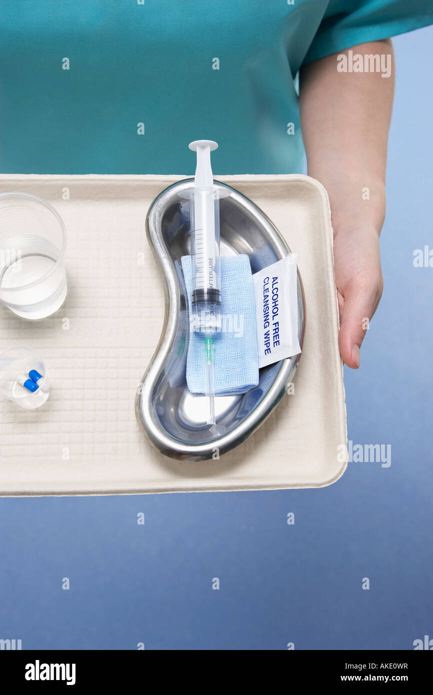 Medical surgeon holding tray with syringe and medication Stock Photo ...