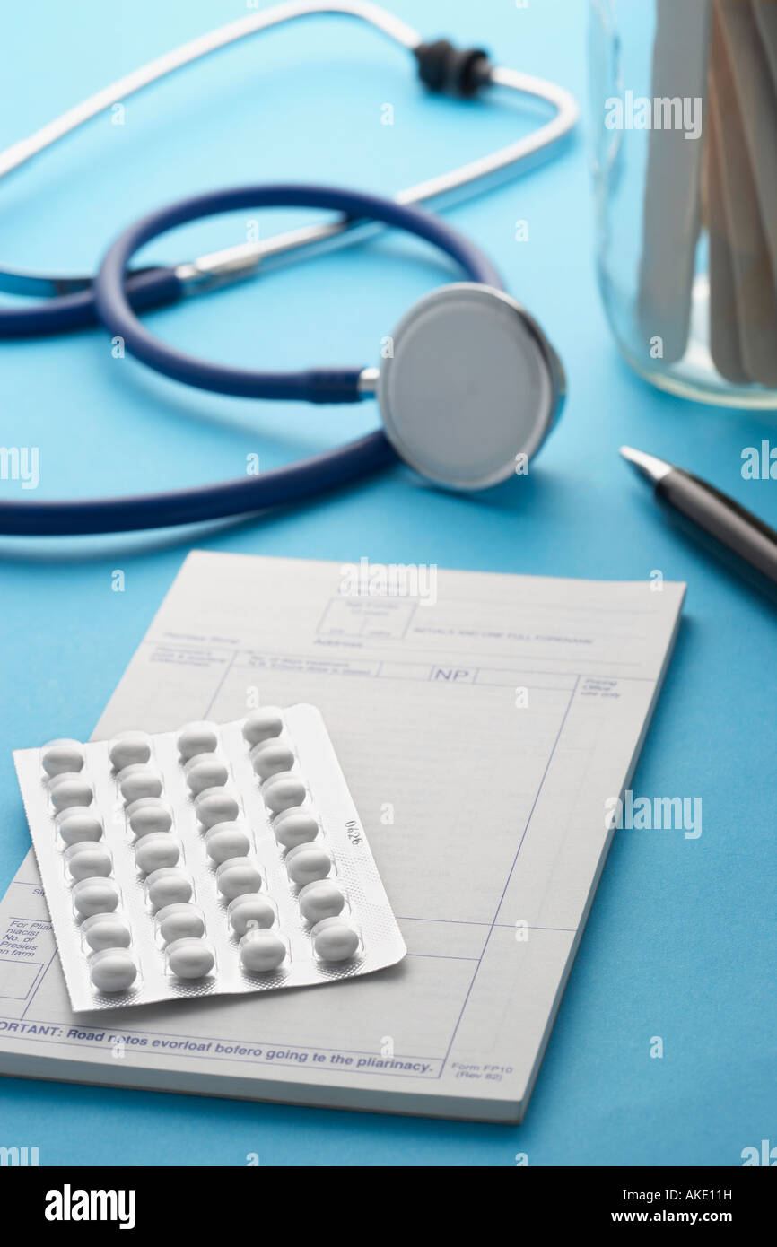 Stethoscope, prescription and medication on doctors table Stock Photo ...