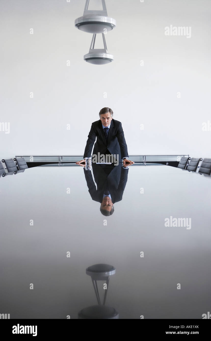 Business man standing at conference table Stock Photo - Alamy