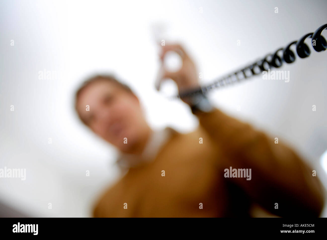 Man making telephone call with focus on the telephone cable Stock Photo ...