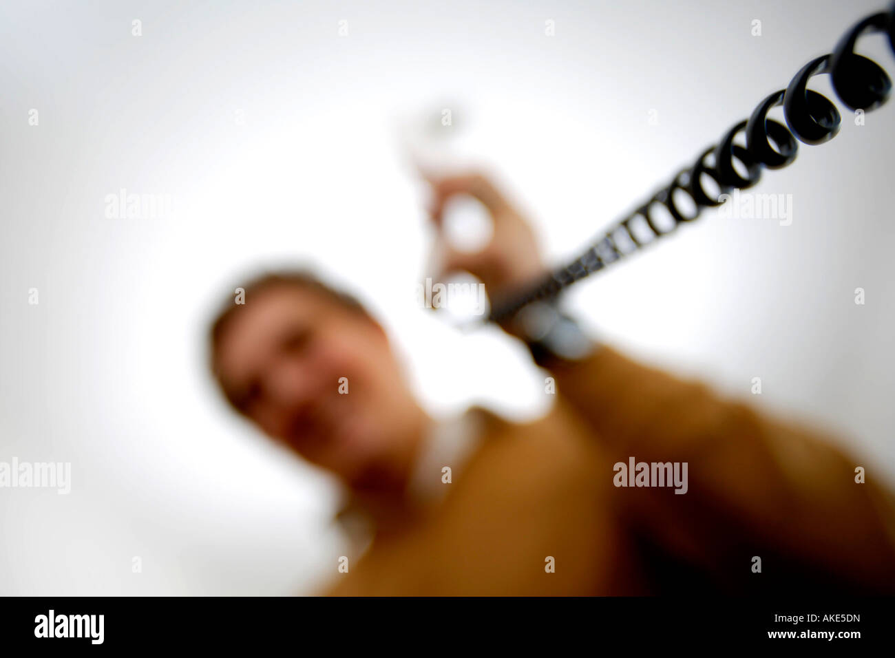 Man making telephone call with focus on the telephone cable Stock Photo ...