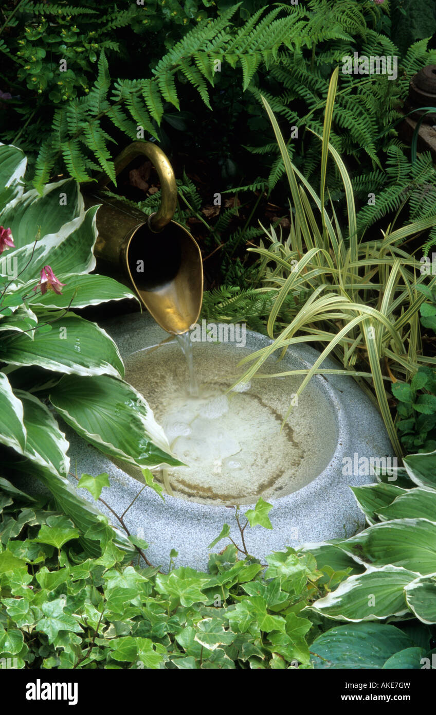 water feature of pitcher fountain and circular ceramic dish bowl Stock ...