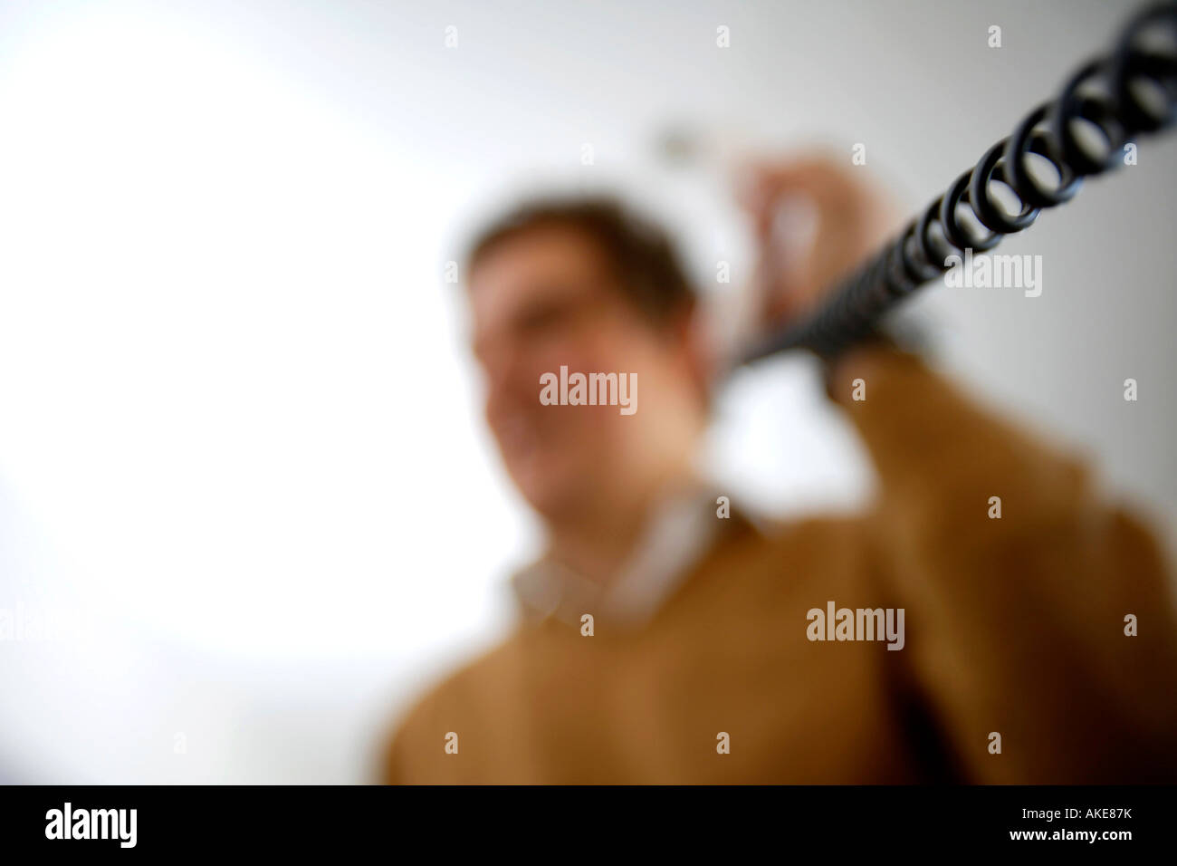 Man making telephone call with focus on the telephone cable Stock Photo ...