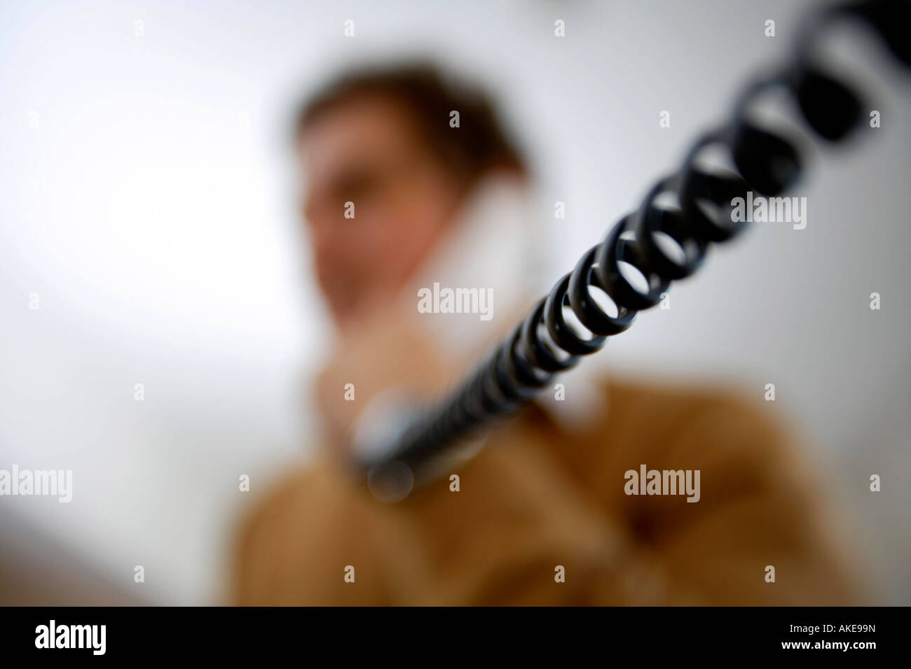 Man making telephone call with focus on the telephone cable Stock Photo ...