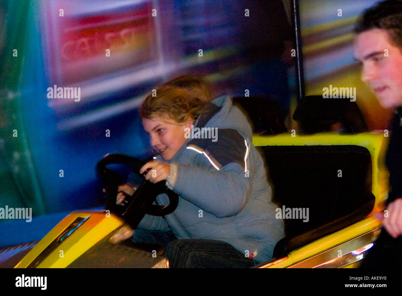 Daredevil little girl driving a bumper car Stock Photo - Alamy