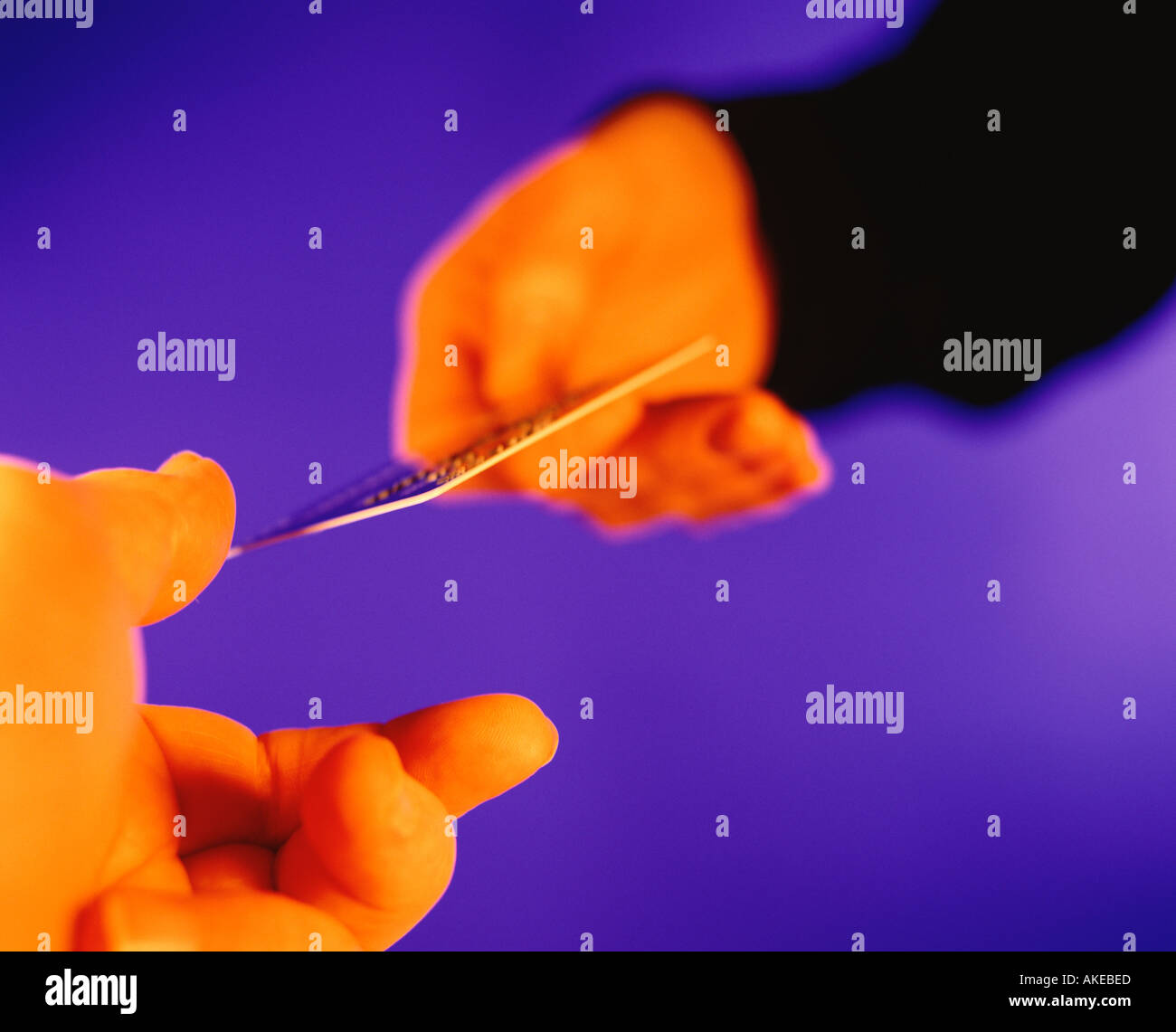 Hand presenting plasic credit debit card blue background Stock Photo ...