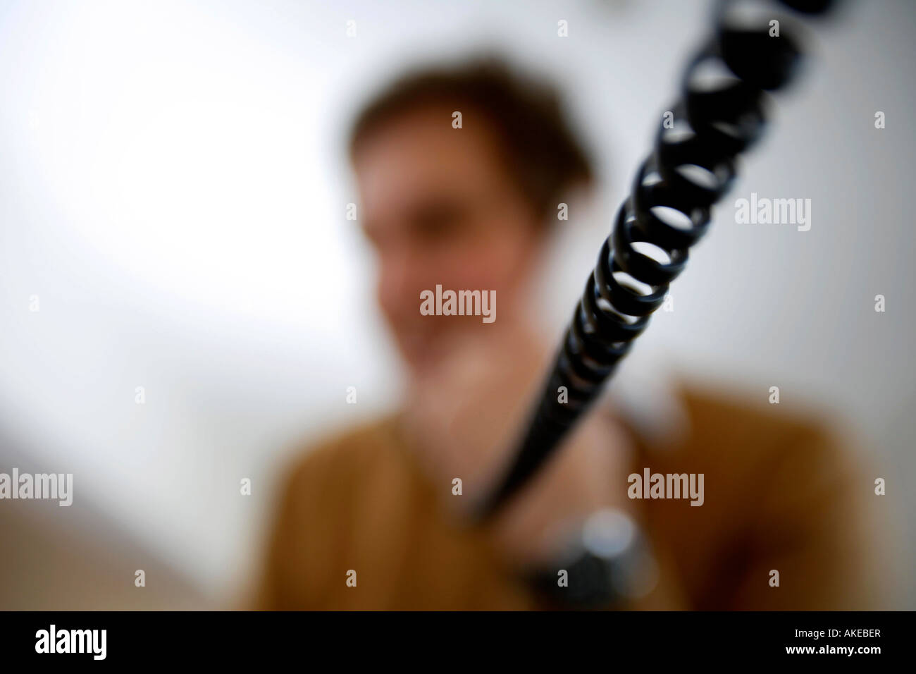 Man making telephone call with focus on the telephone cable Stock Photo ...
