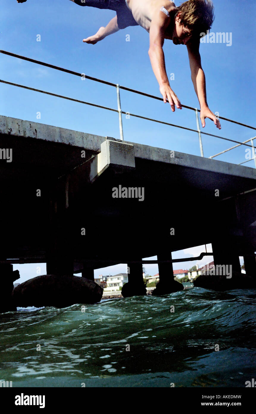 A young man jumping into the water Stock Photo - Alamy