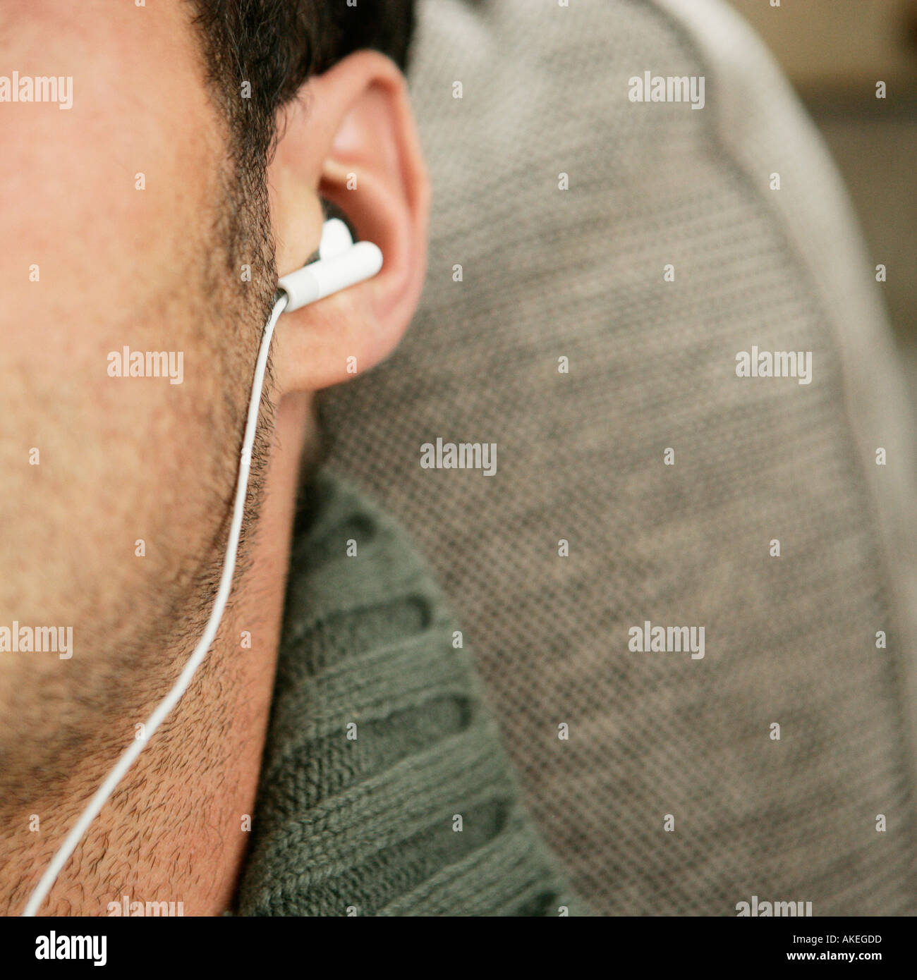 Close up of small white headphone in man s ear Stock Photo - Alamy