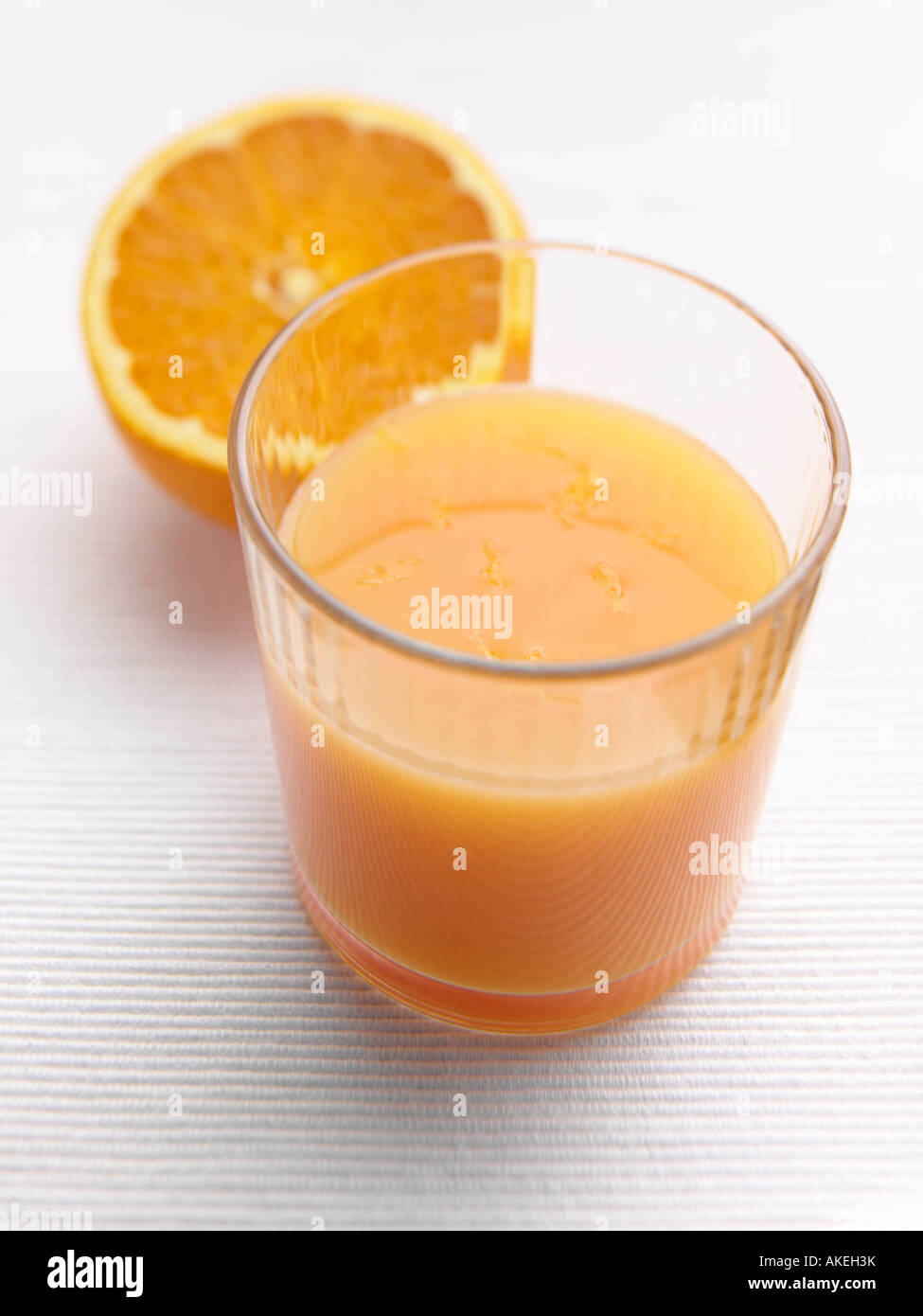 A cut orange with a glass of orange juice editorial food Stock Photo ...
