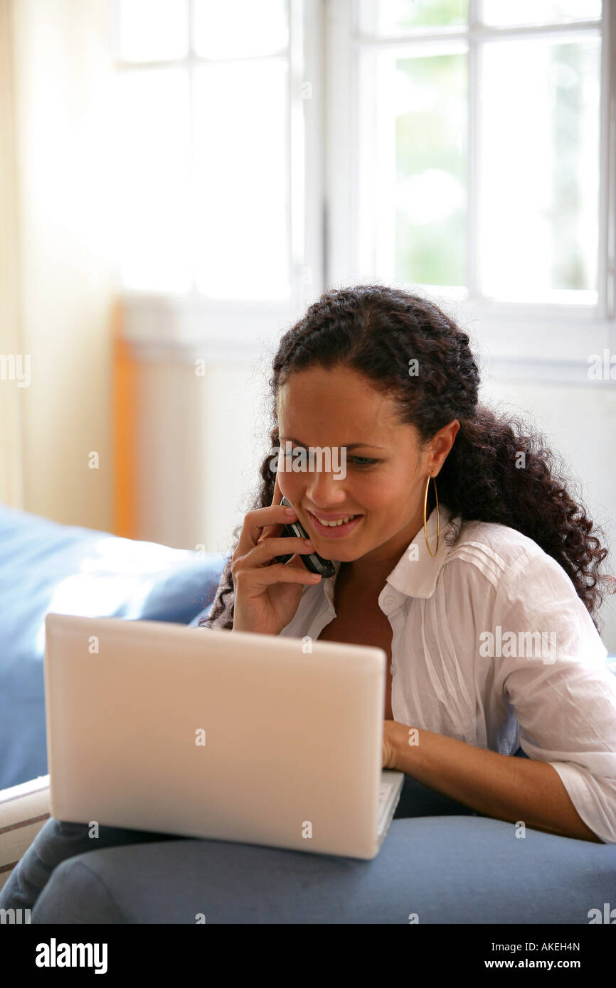 young woman with mobile phone and laptop computer Stock Photo - Alamy