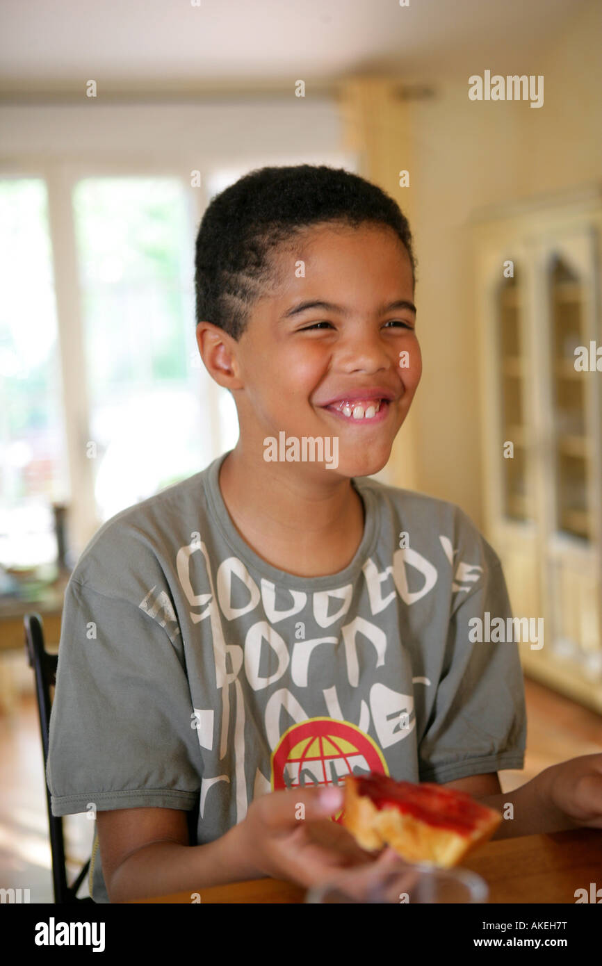 metis boy having a snack at home Stock Photo - Alamy