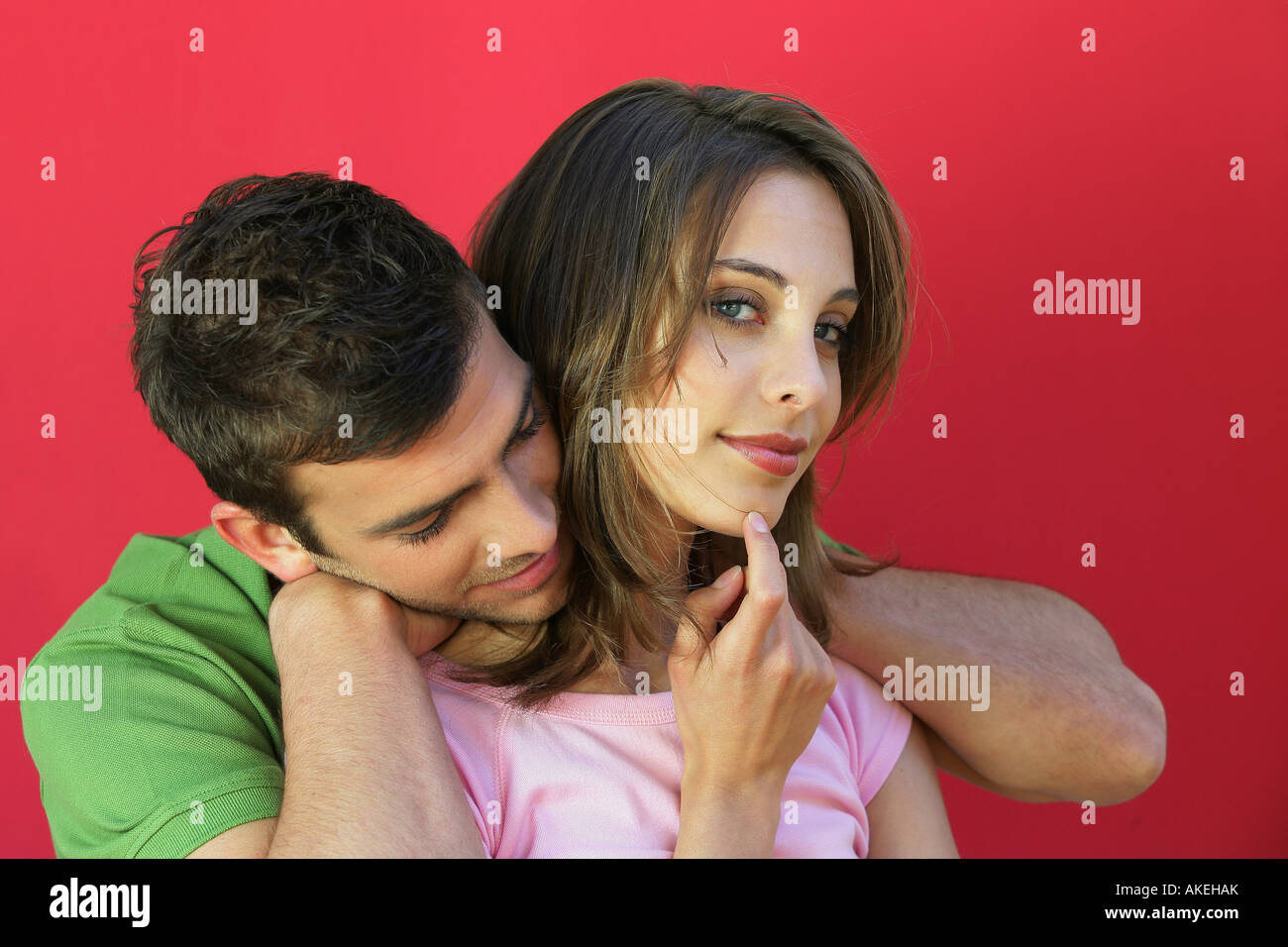 young couple in red background Stock Photo - Alamy