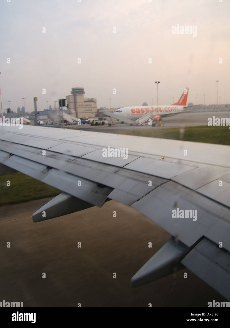 view of wing and airport runway from plane window Stock Photo - Alamy