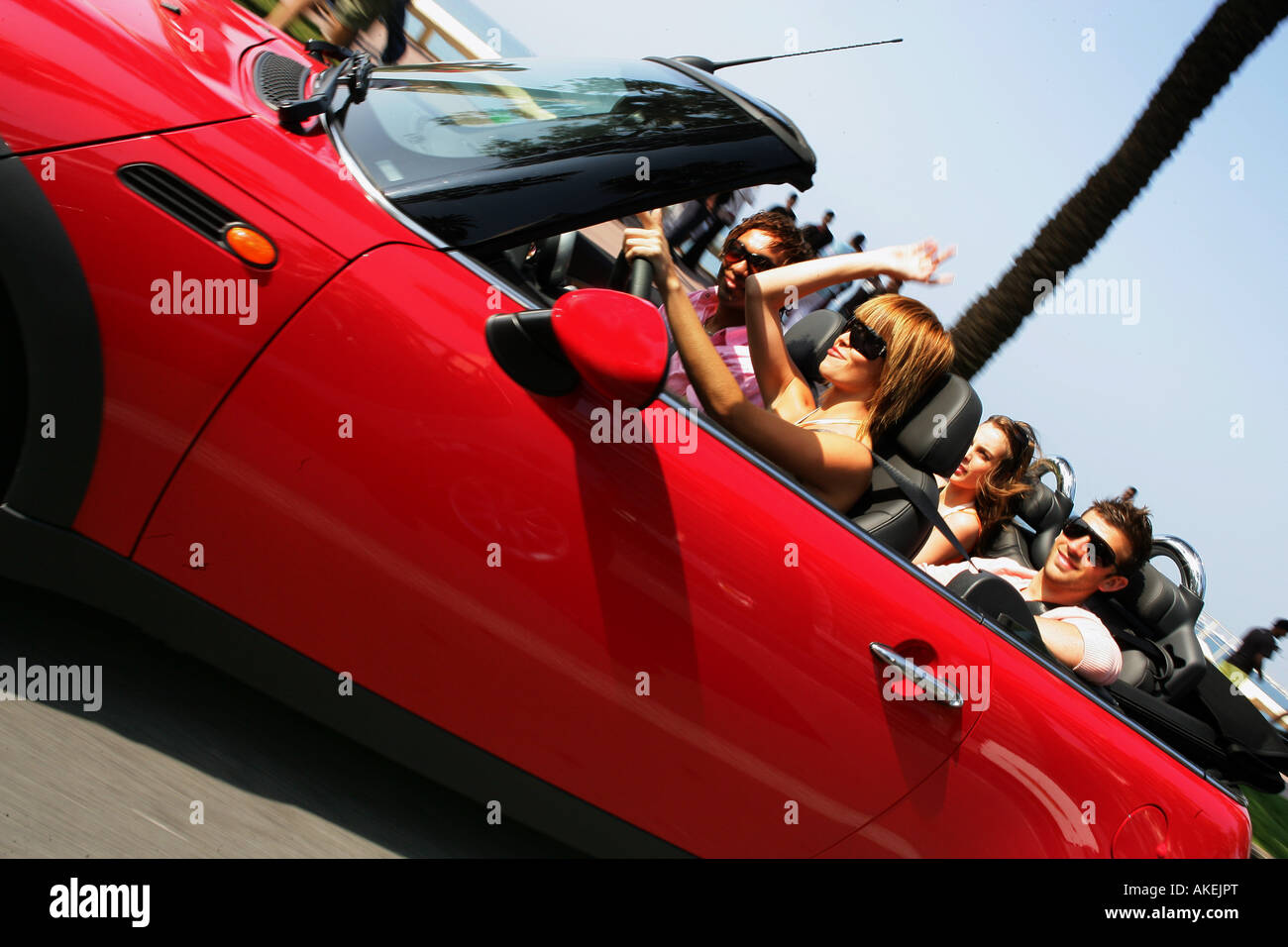 friends riding in a red car Stock Photo - Alamy