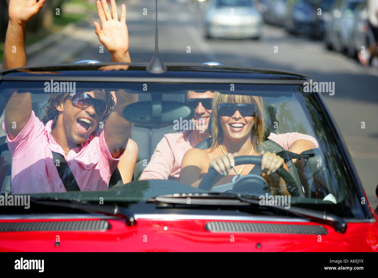friends in a red convertible car Stock Photo - Alamy