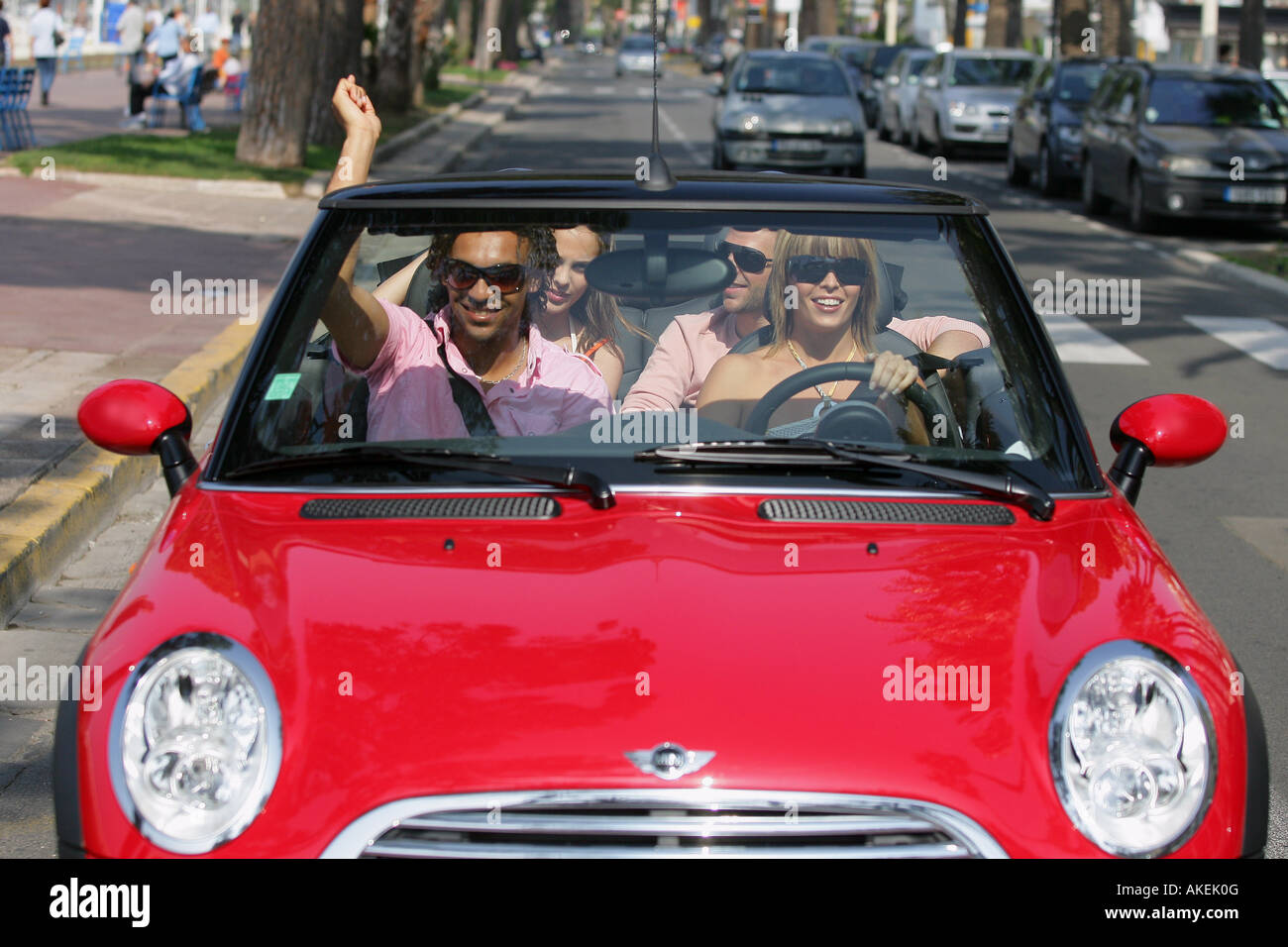 friends in a red convertible car Stock Photo - Alamy