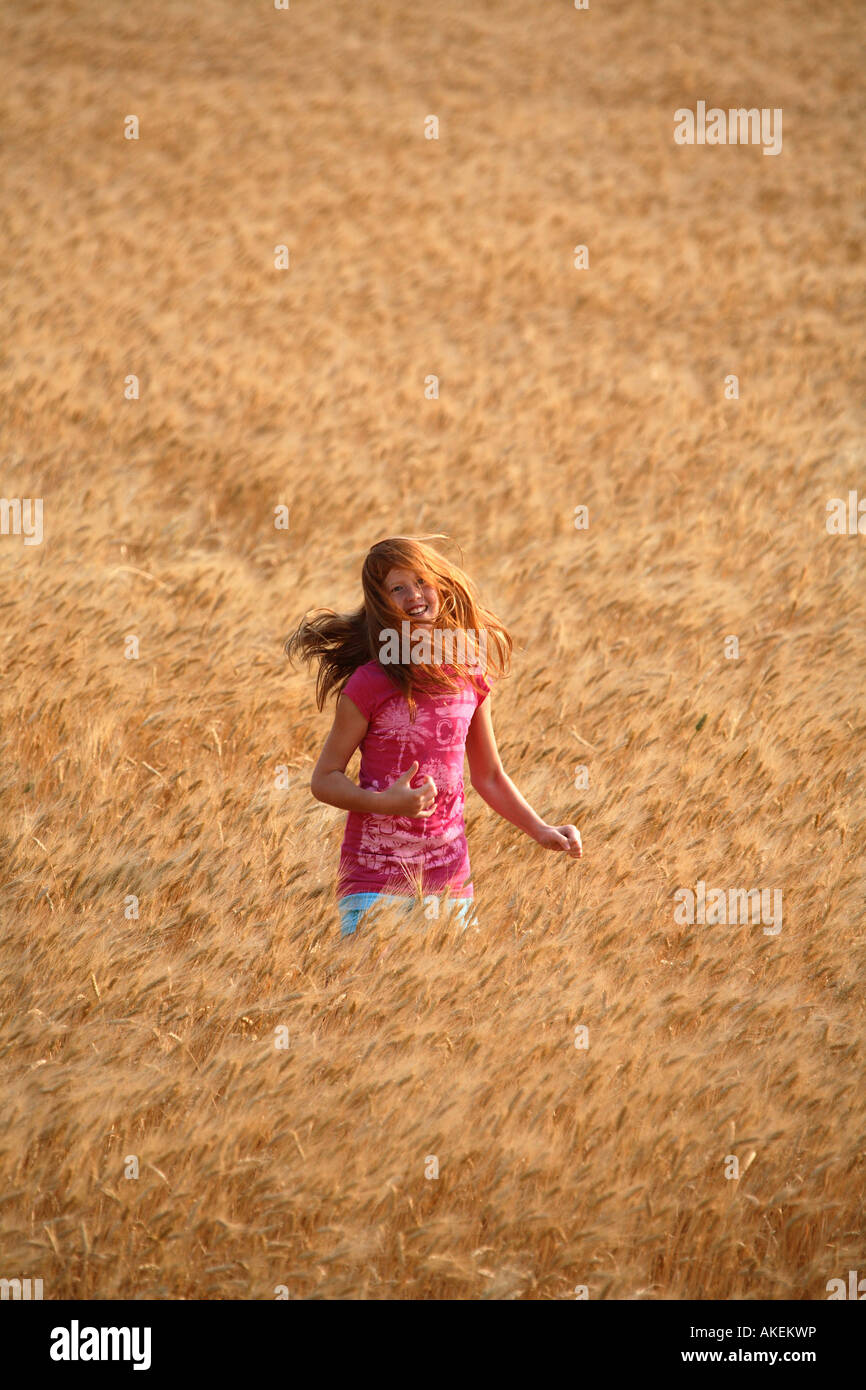 Girl running through wheat field hi-res stock photography and images ...