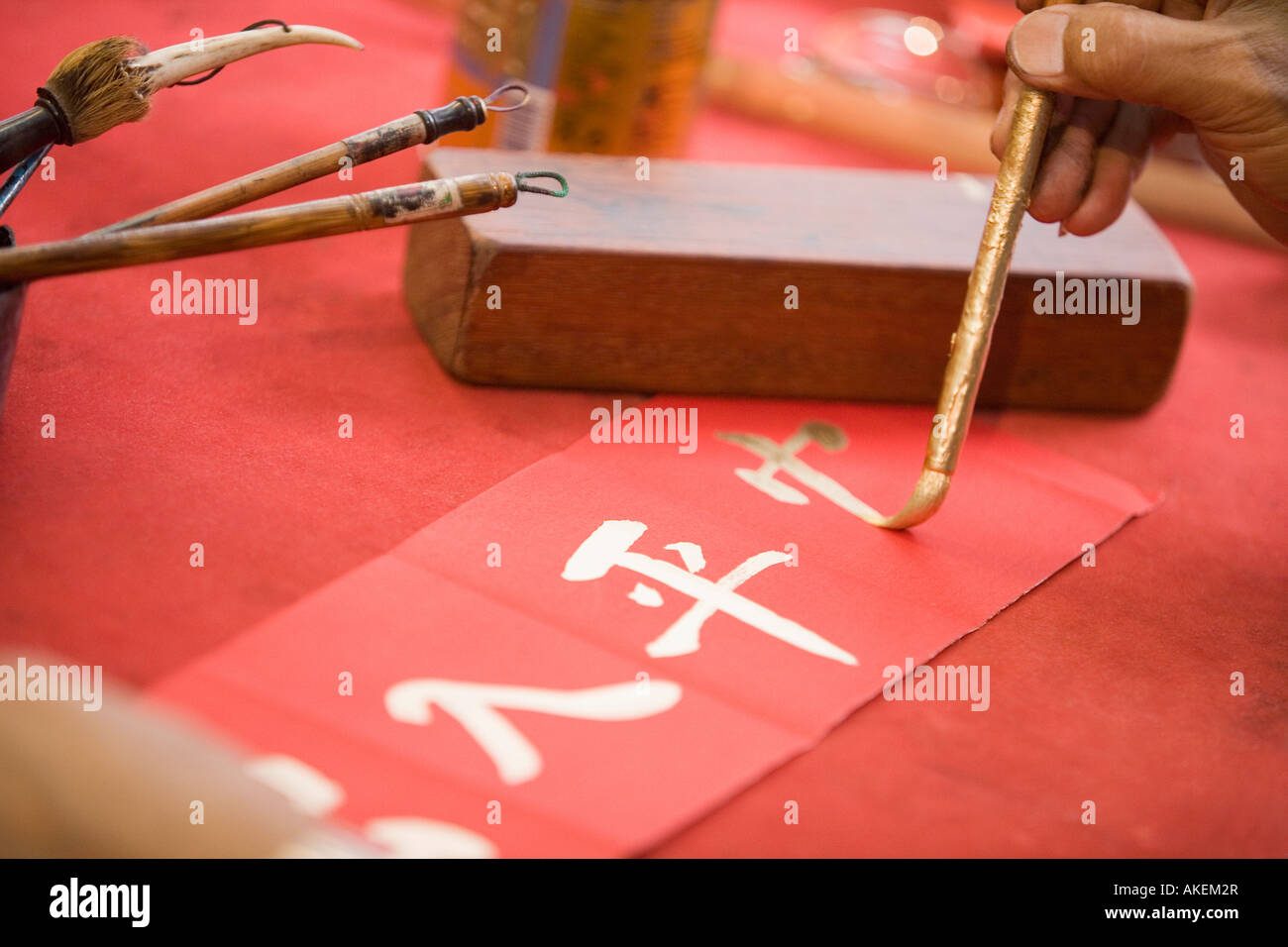 Close-up of a person's hand painting Chinese script Stock Photo - Alamy