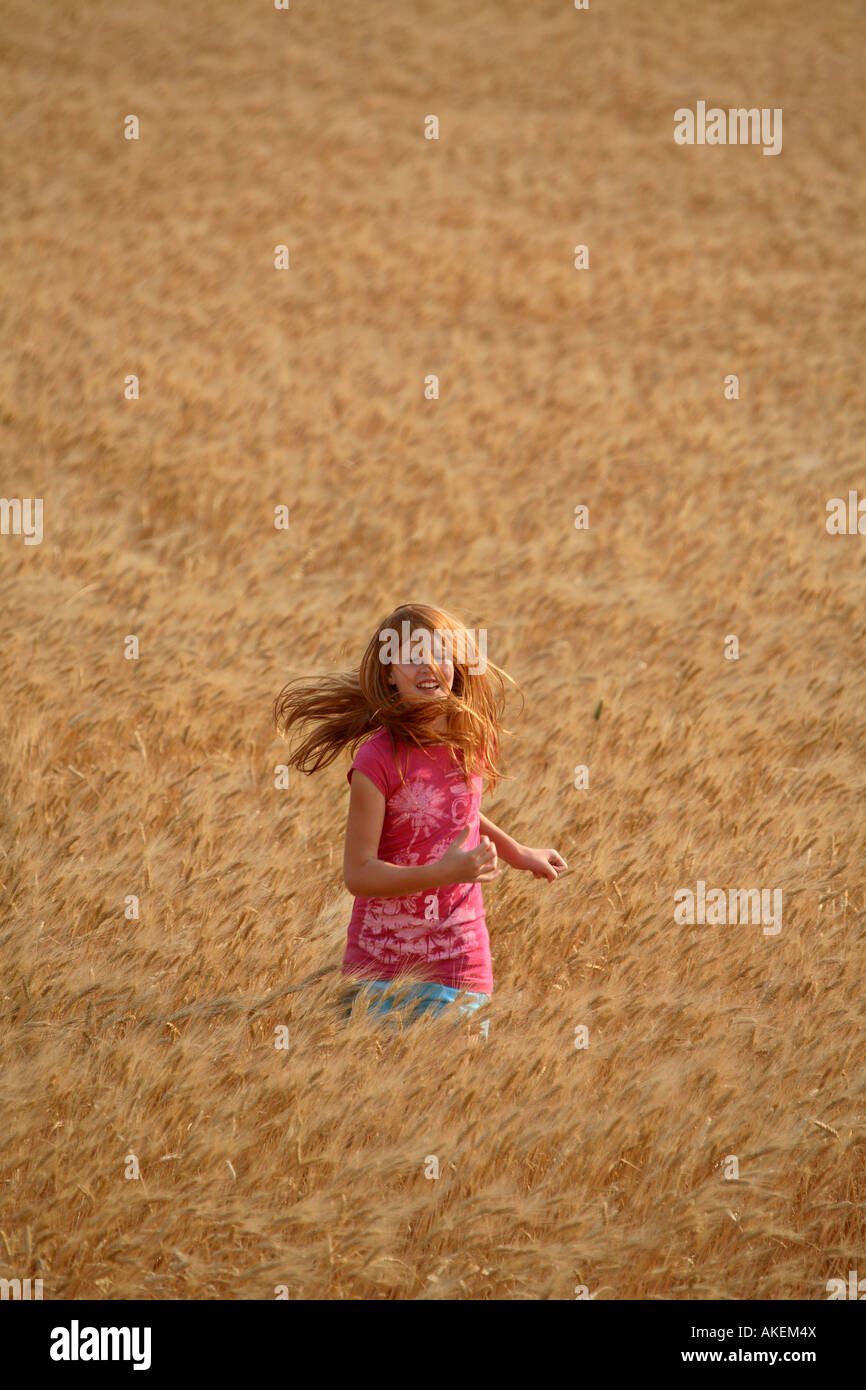 Girl running through wheat field hi-res stock photography and images ...