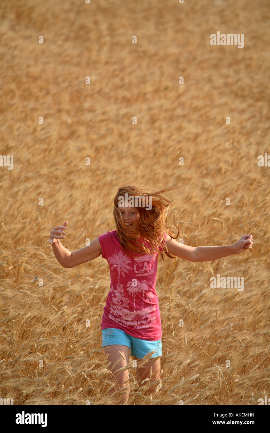 Girl running through wheat field hi-res stock photography and images ...