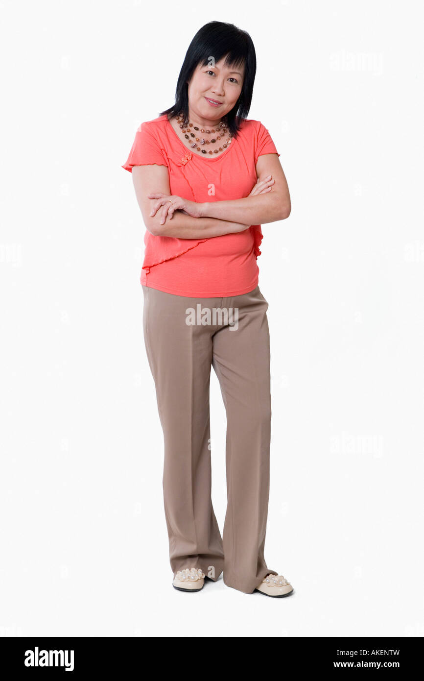 Portrait of a mature woman standing with her arms crossed Stock Photo ...