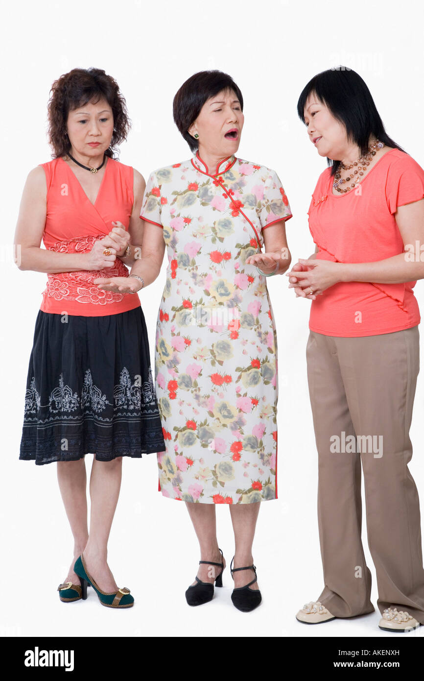 Two senior women and a mature woman standing together and talking Stock ...