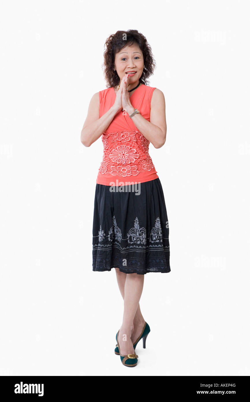 Portrait of a senior woman standing with her arms folded Stock Photo ...