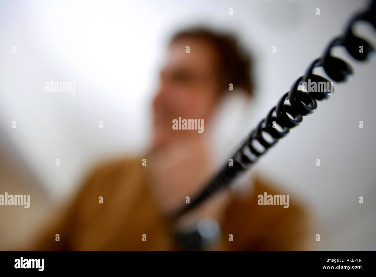 Man making telephone call with focus on the telephone cable Stock Photo ...
