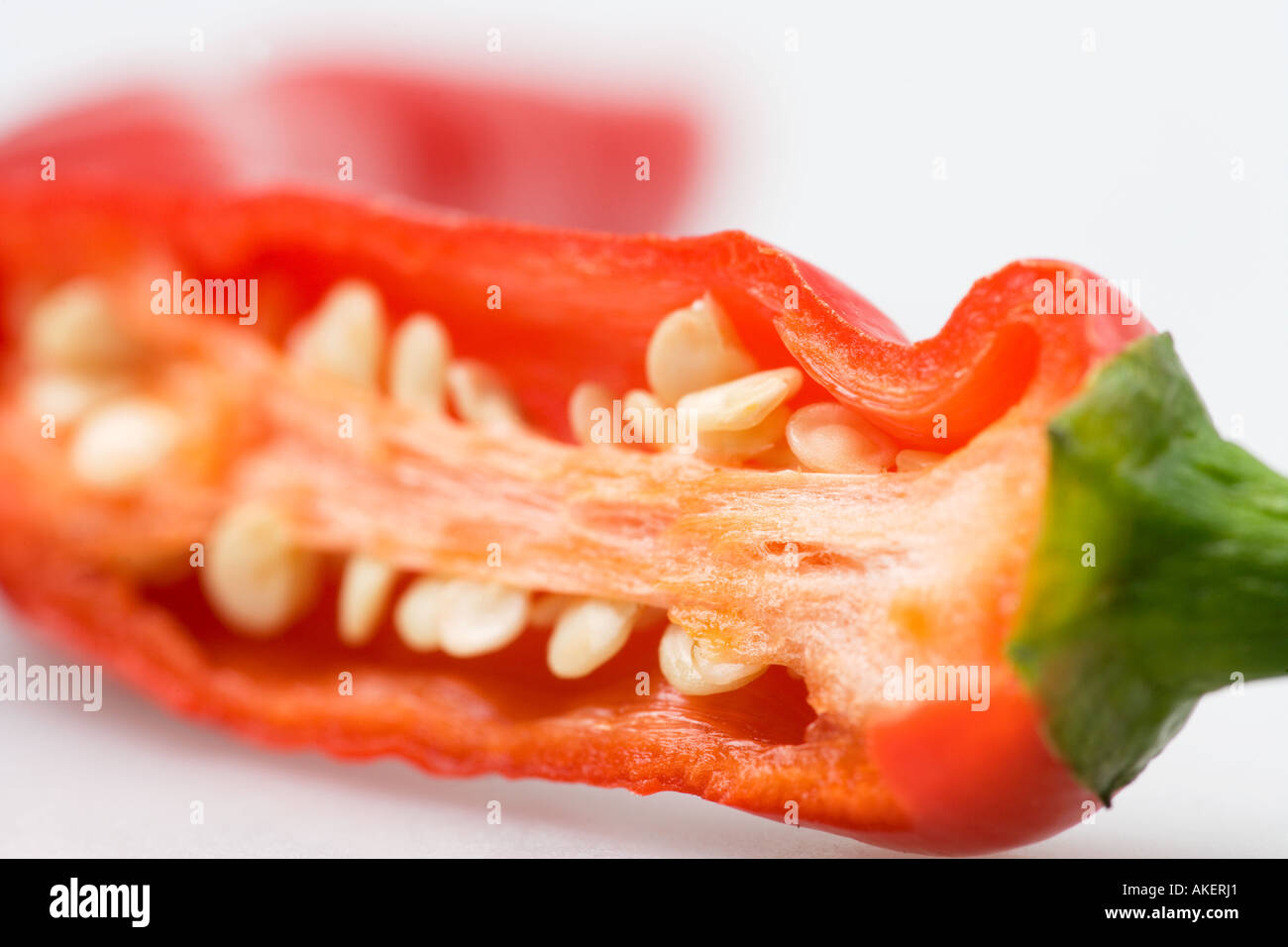 Hot red chilli sliced to show seeds Stock Photo - Alamy