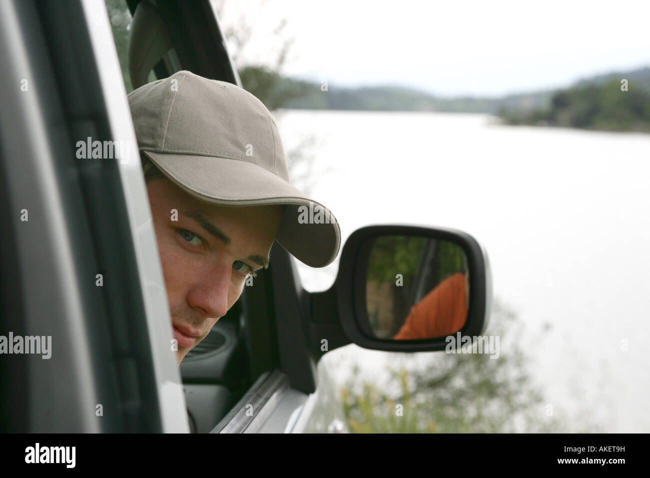 young man in car wearing a cap Stock Photo - Alamy