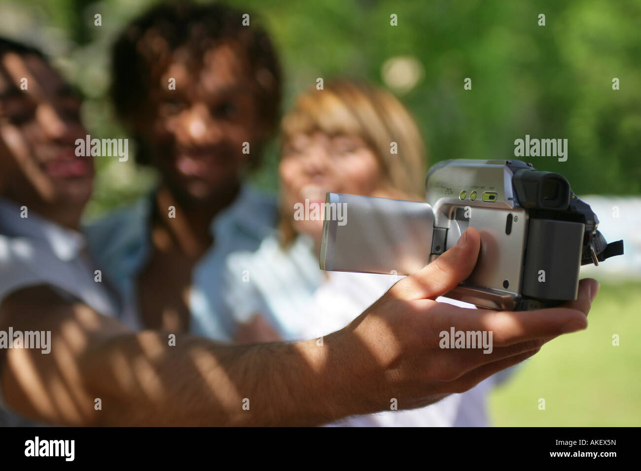 friends with video camera Stock Photo - Alamy