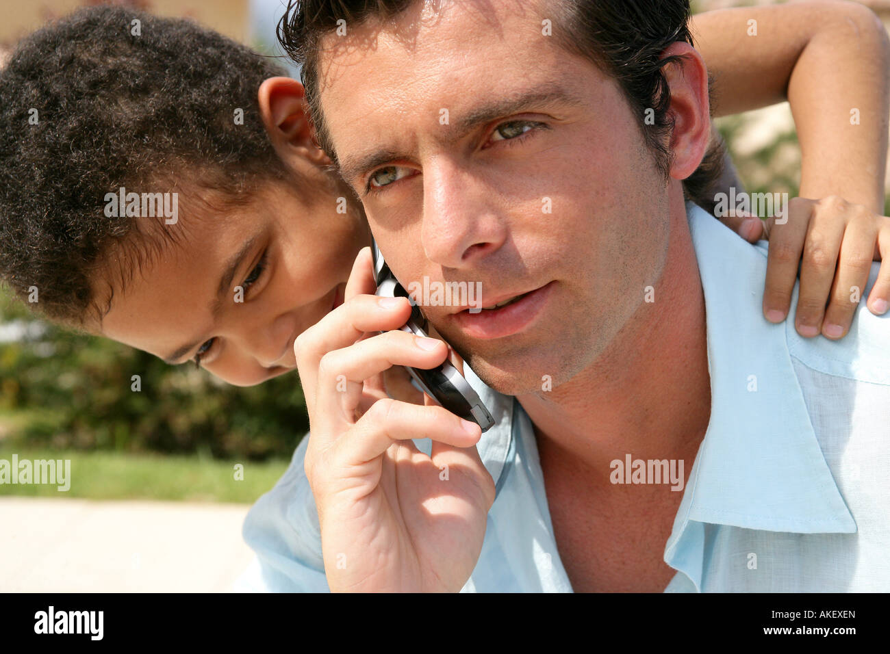 young man and child with mobile phone Stock Photo - Alamy