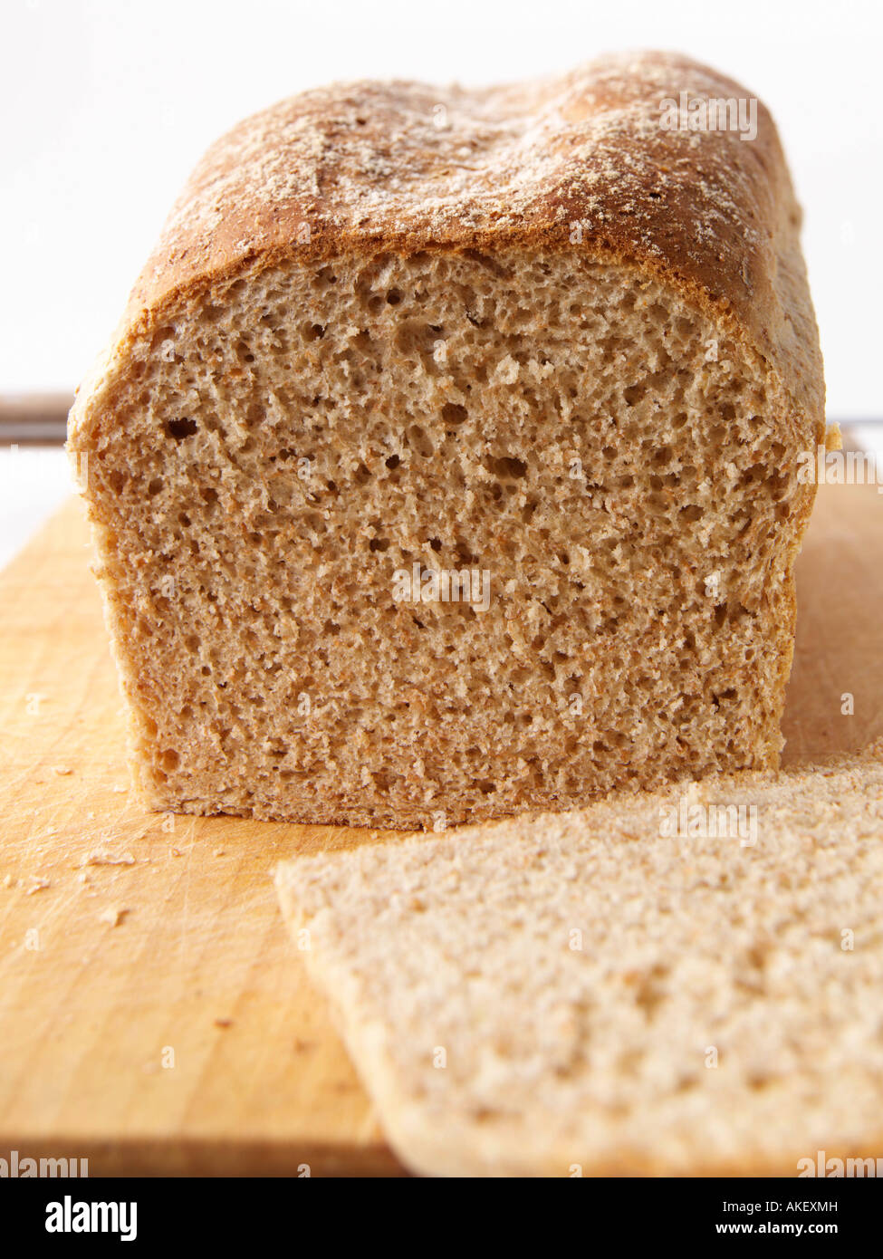 A whole brown loaf cut showing texture bread making editorial food ...