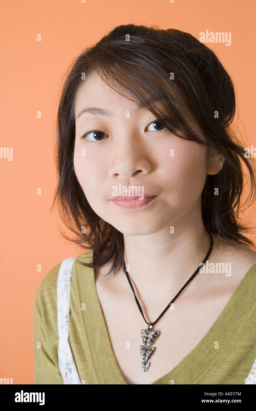 Portrait of a young woman looking serious Stock Photo - Alamy