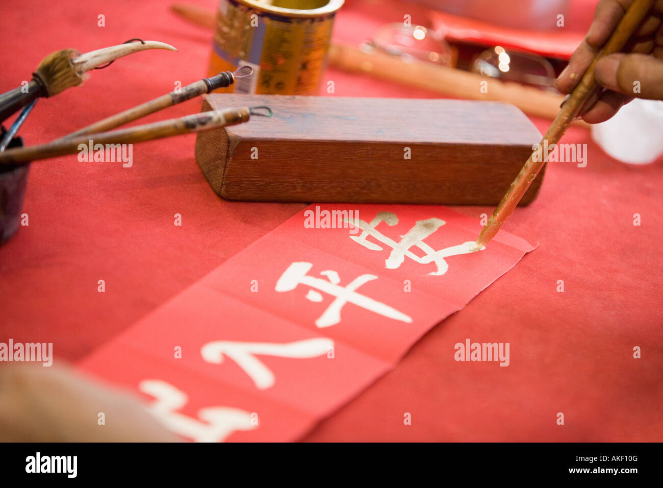 Close-up of a person's hand painting Chinese script Stock Photo - Alamy