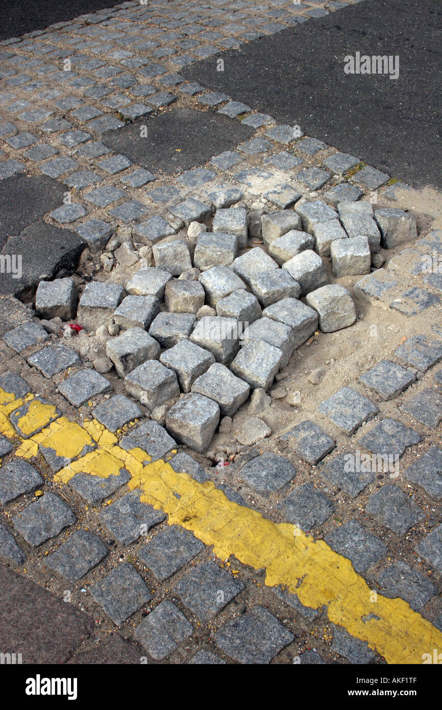 street pebbles placed to cover hole Stock Photo - Alamy