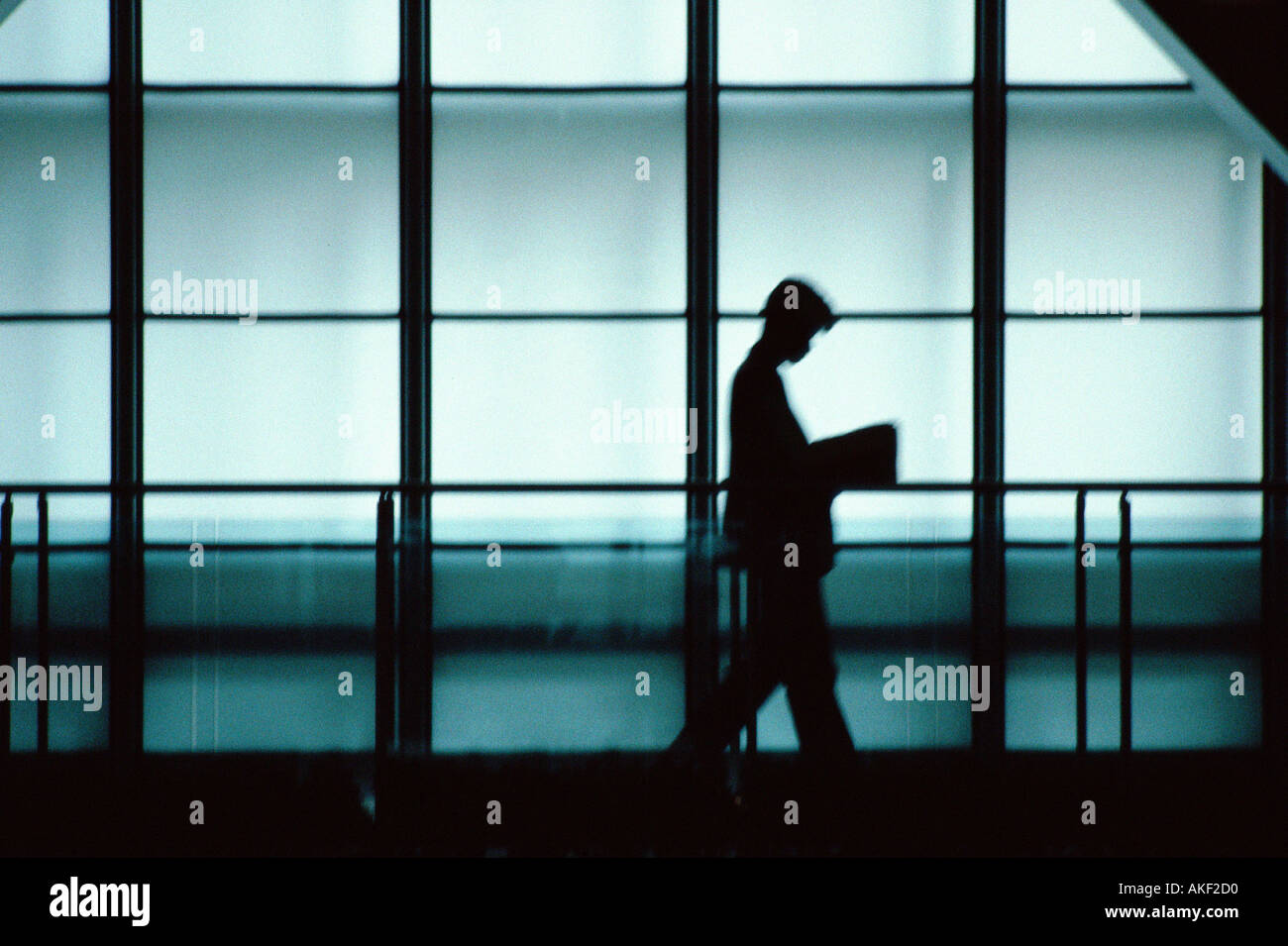 Man walking along corridor Stock Photo - Alamy