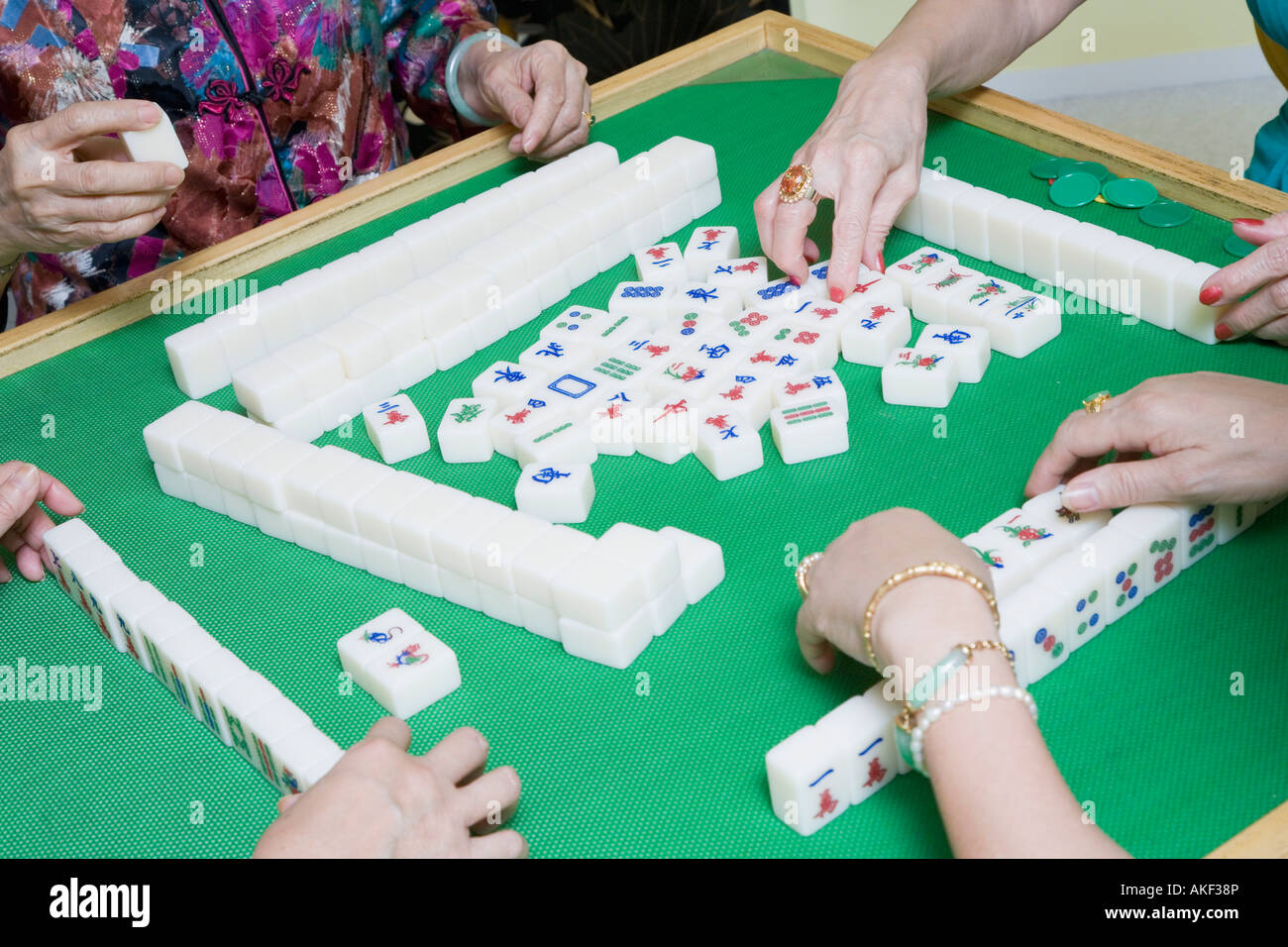 Four women playing mahjong Stock Photo - Alamy
