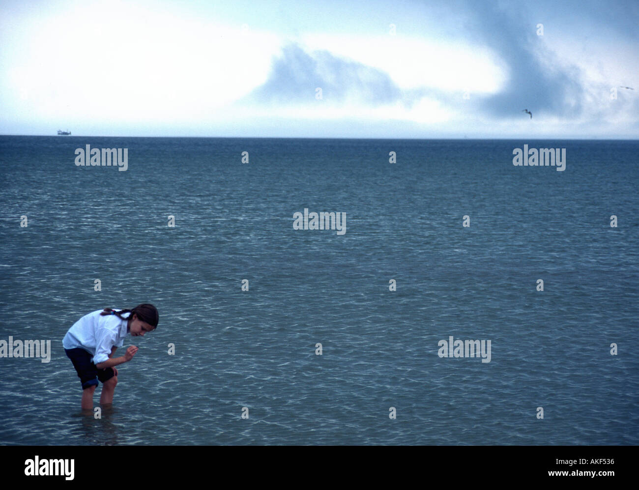 Girl wading ocean hi-res stock photography and images - Alamy