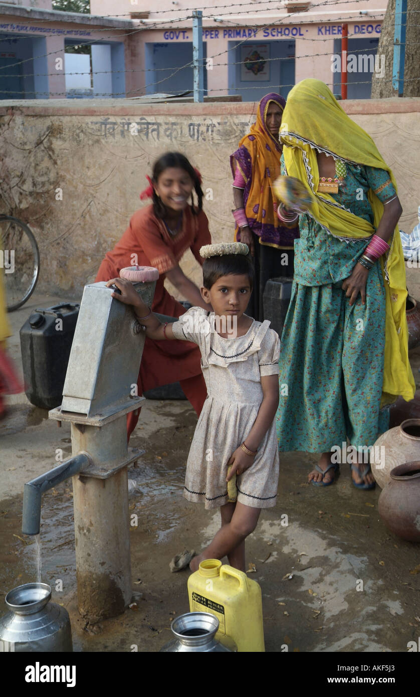 Village women water hand pump hi-res stock photography and images - Alamy