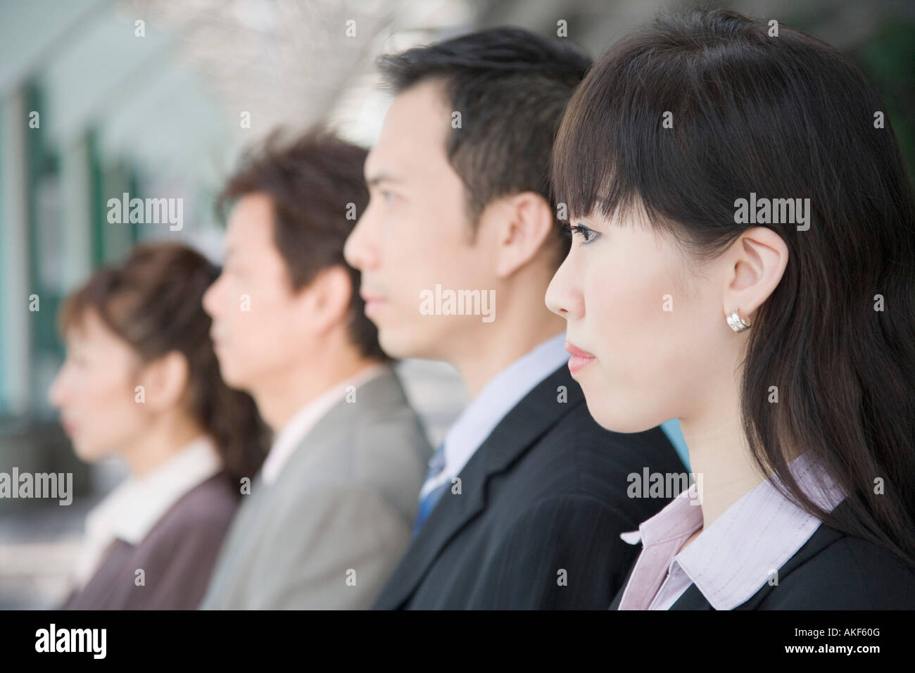 Side profile of four business executives side by side Stock Photo - Alamy