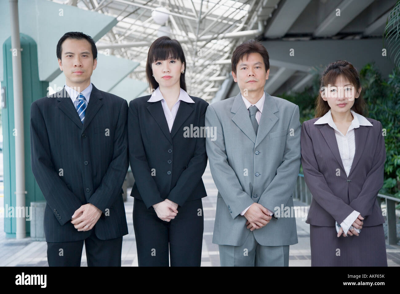Portrait of four business executives standing side by side Stock Photo ...